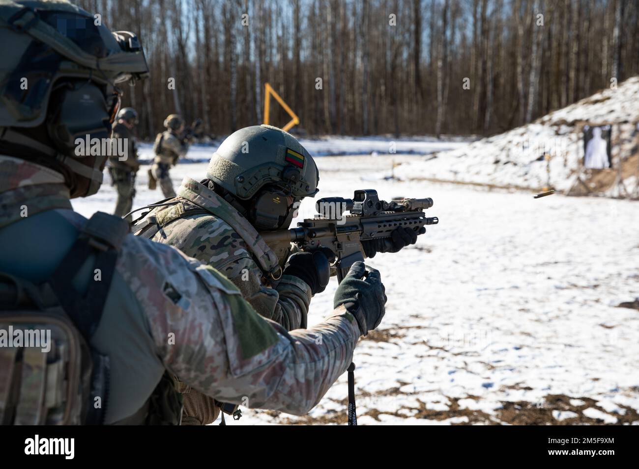 A Lithuanian SOF Jaeger fires their weapon when an audio tone is heard ...