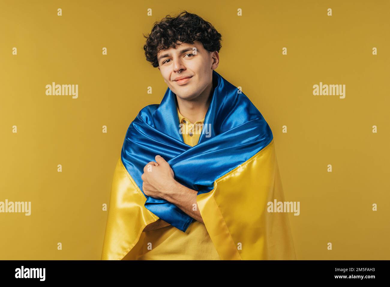 Smiling man with national Ukrainian flag on yellow. Ukraine, patriot ...