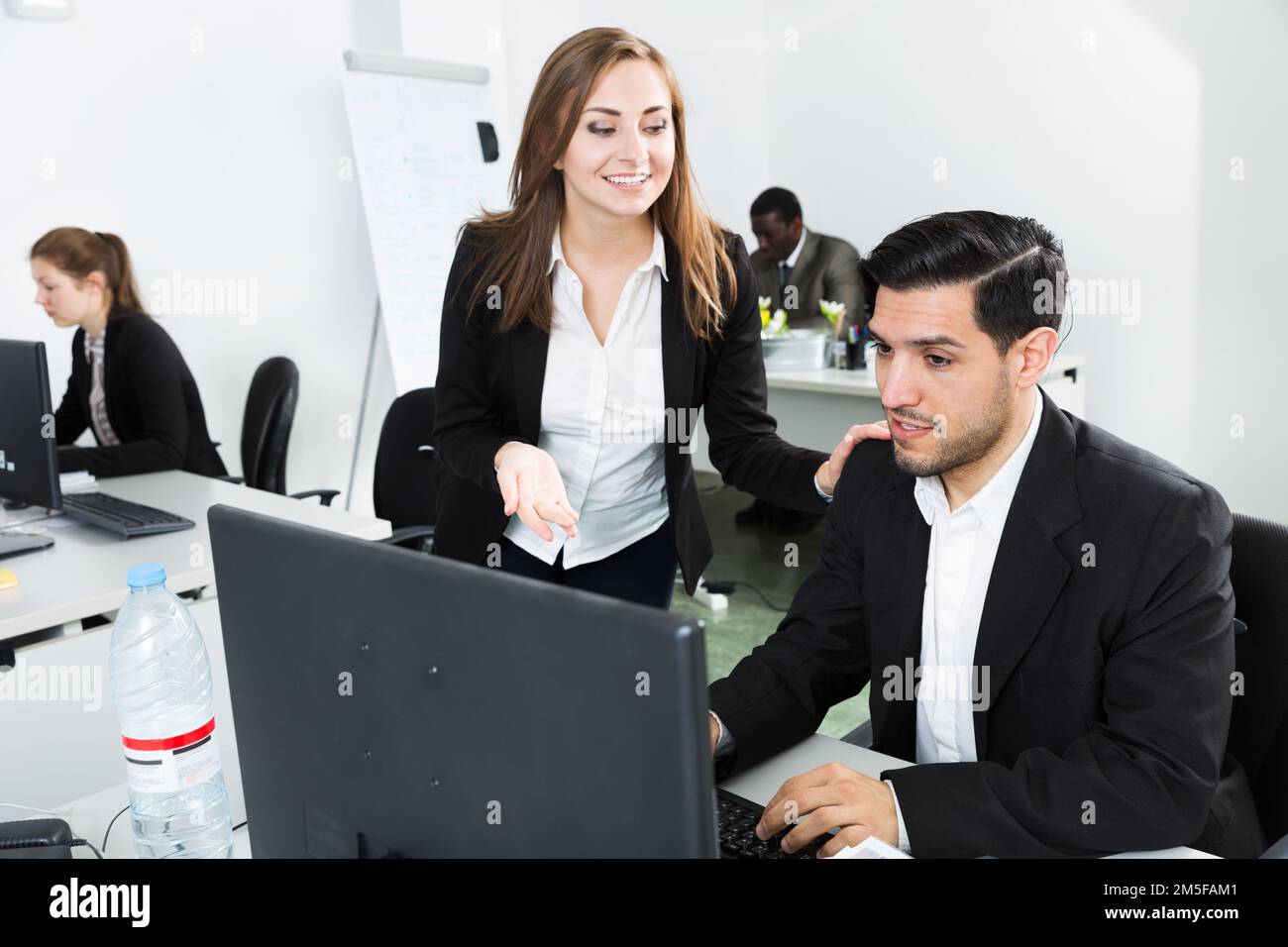 Business woman explaining something to male coworker Stock Photo - Alamy
