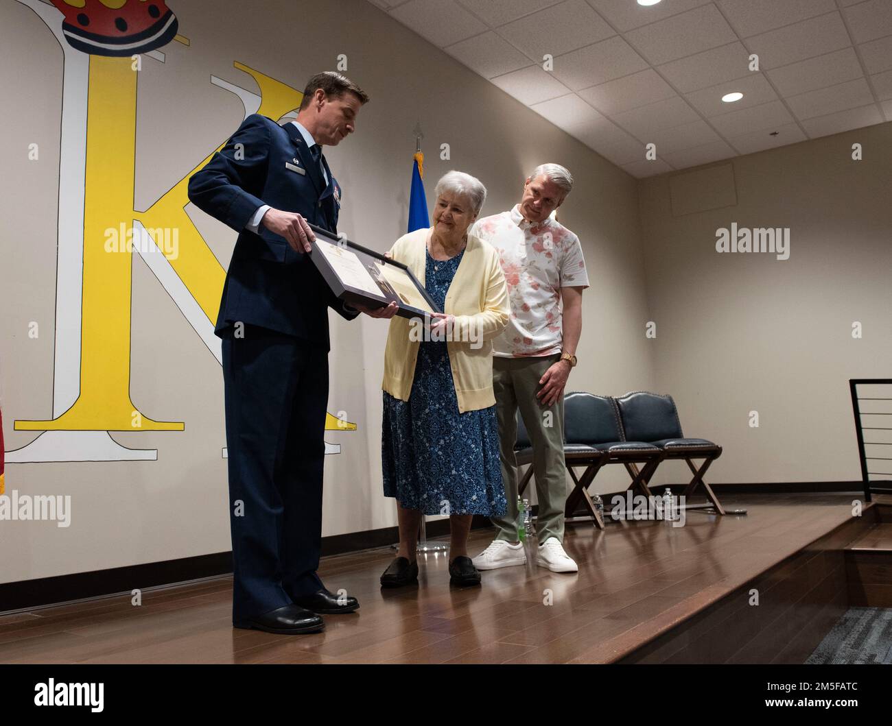 U.S. Air Force Col. Rus Cook, 23rd Wing commander, presents an Airman’s ...