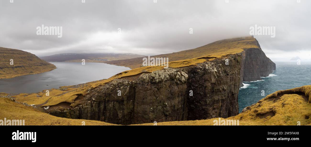 Leitisvatn lake over the ocean cliffs seen from Trælanípa Stock Photo ...