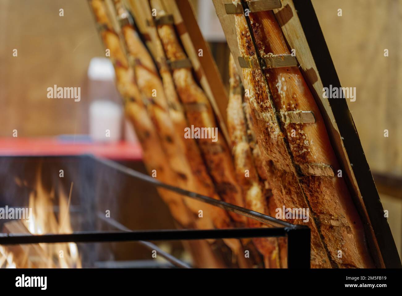 Selective focus and night view of burning fire and hanging grilled ...