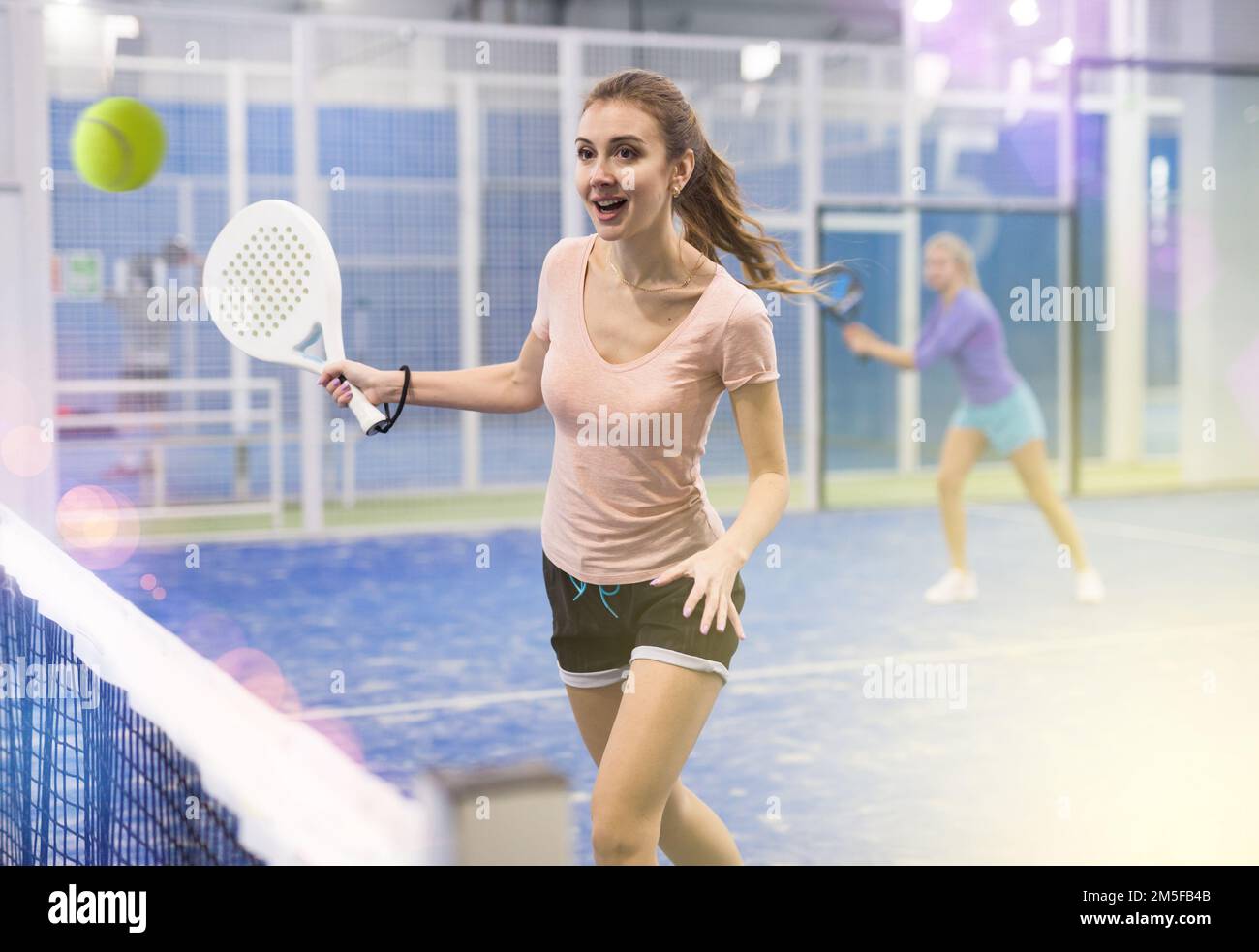 Portrait of a young woman playing padel Stock Photo - Alamy