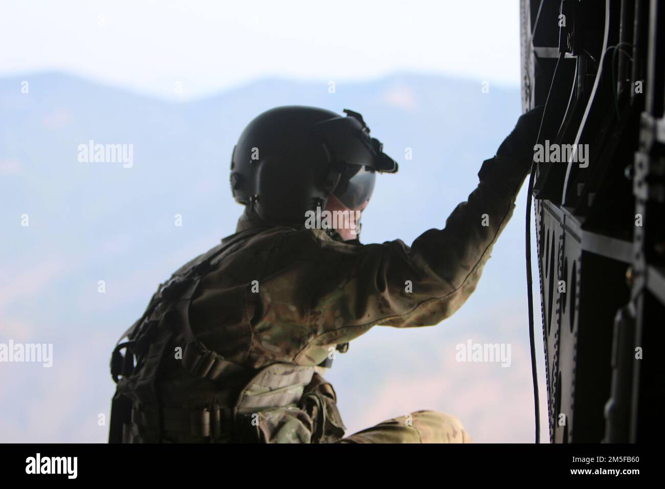 Soldier assigned to 3-2 General Support Aviation Battalion looks out ...