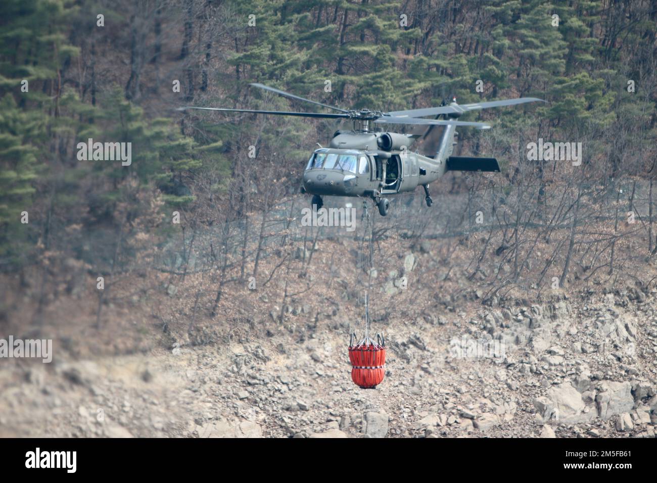 A UH-60 Blackhawk helicopter retrieves water from Kach’ang-josuji water ...