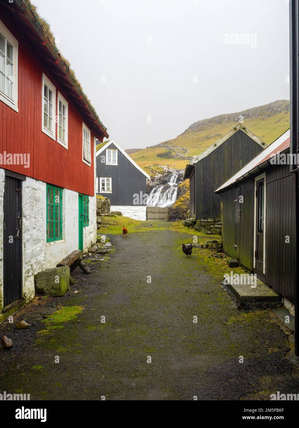 Mykines street with a waterfall at th end Stock Photo - Alamy