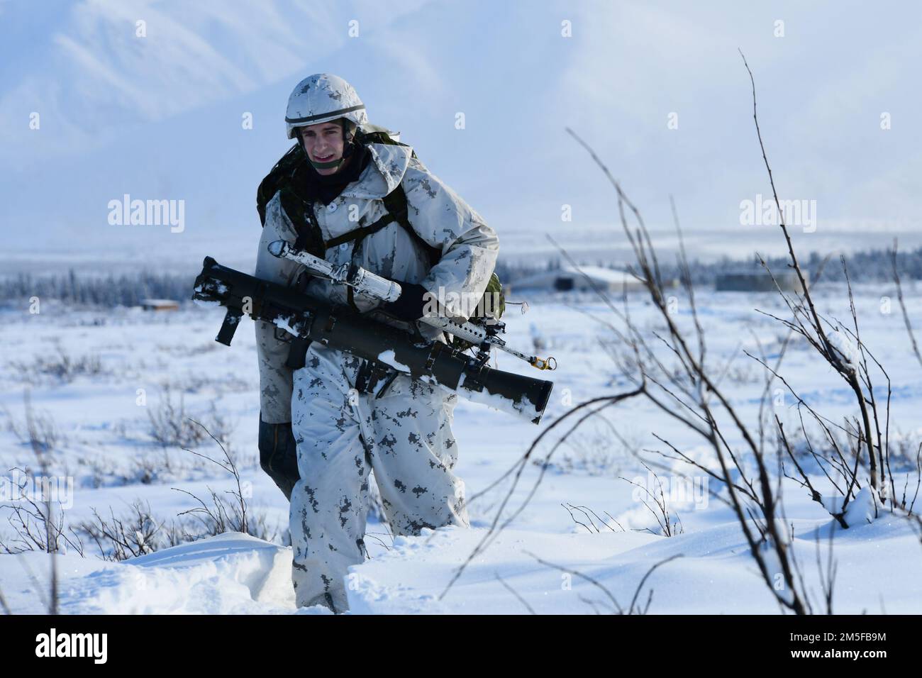 A Canadian paratrooper walks off the drop zone after a Joint Forcible ...
