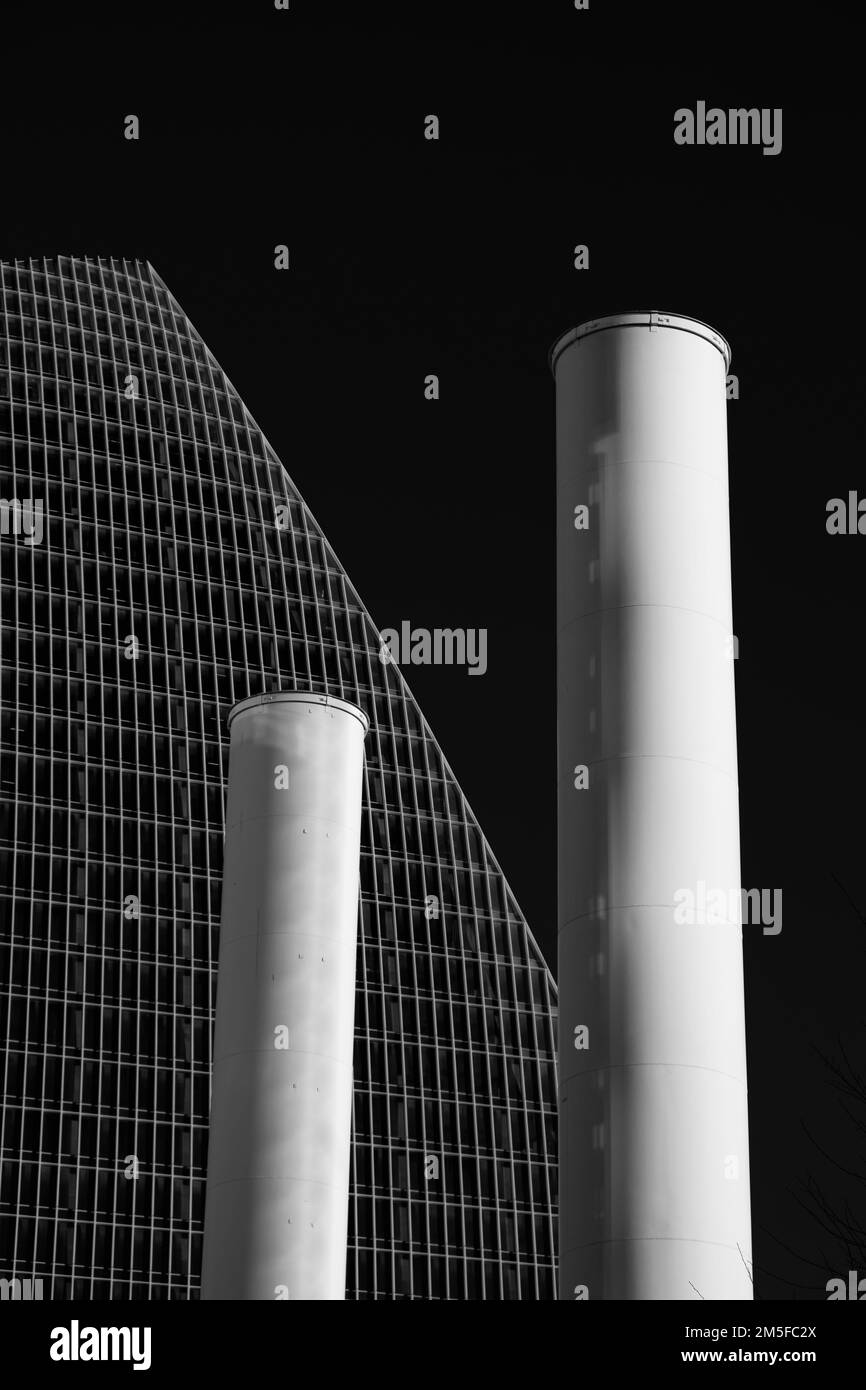 A grayscale vertical shot of two chimneys of a building isolated on ...