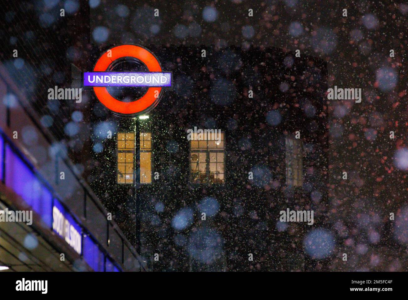 A London Underground roundel is illuminated at Stockwell tube station ...