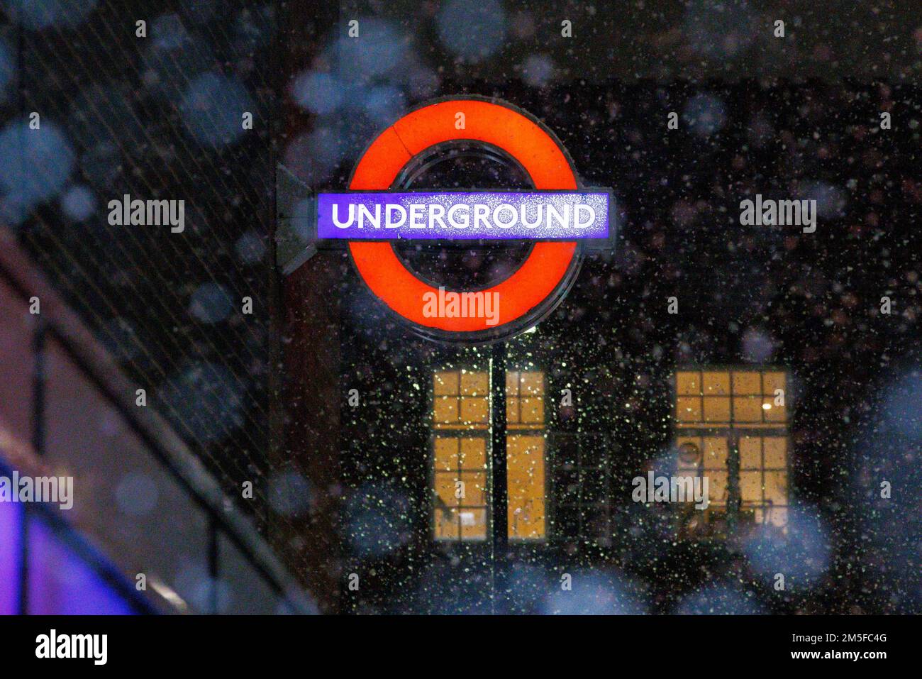 A London Underground roundel is illuminated at Stockwell tube station ...