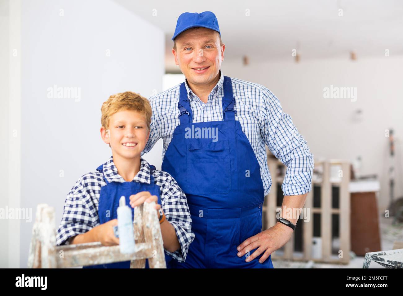 Portrait of positive father and son builders Stock Photo - Alamy