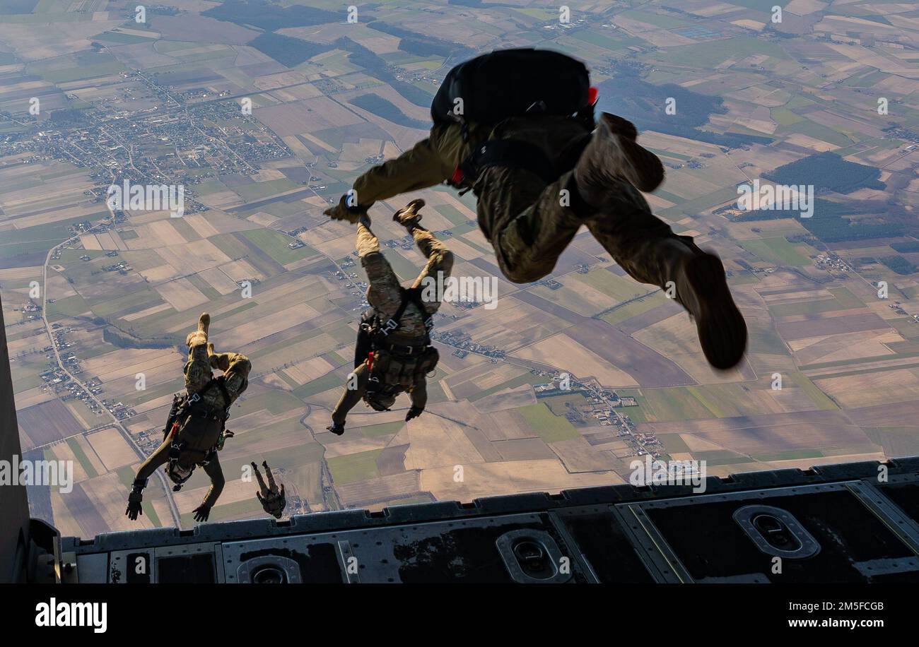 Polish Special Forces Operators execute a military free fall jump from ...