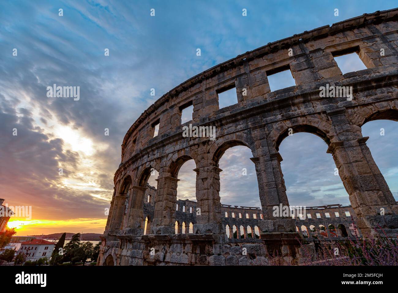 sunset on Pula Amphitheater or Coliseum of Pula is a well-preserved ...