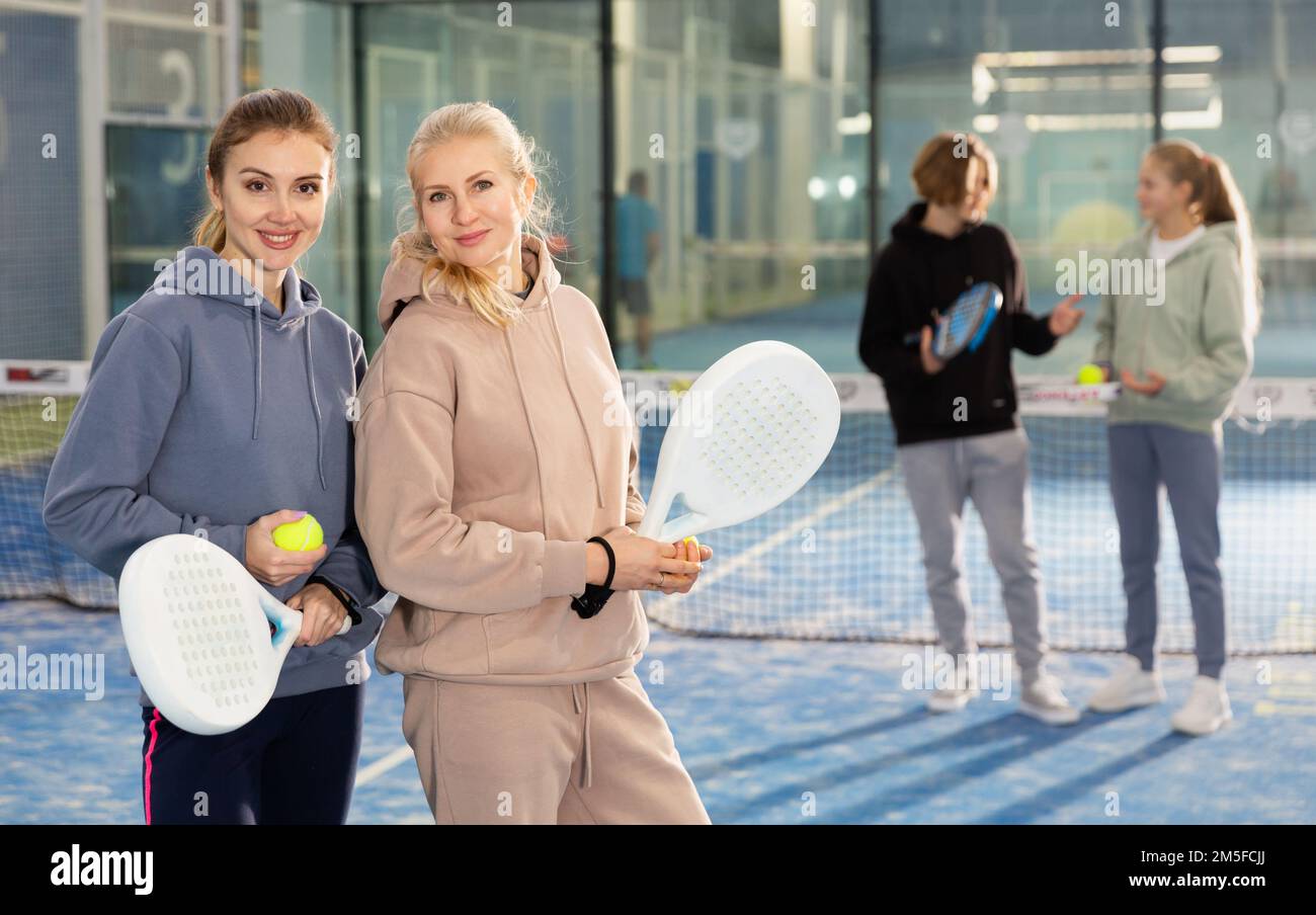 Portrait of two women with rackets and padel ball Stock Photo - Alamy