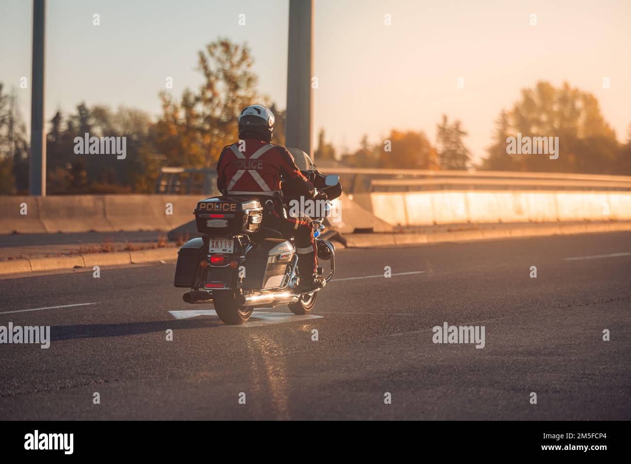 A police officer riding away into the sunset on a motorcycle Stock ...