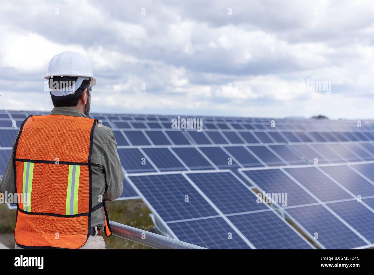 An engineer checking the operation in a field of photovoltaic solar ...