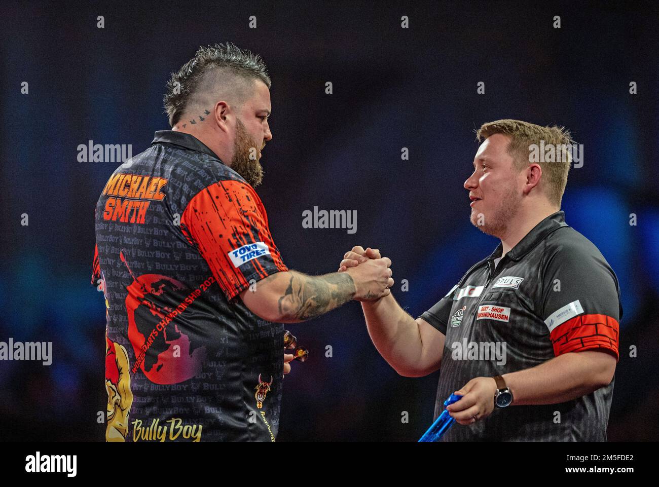 Michael Smith shakes hands with Martin Schindler after winning his ...
