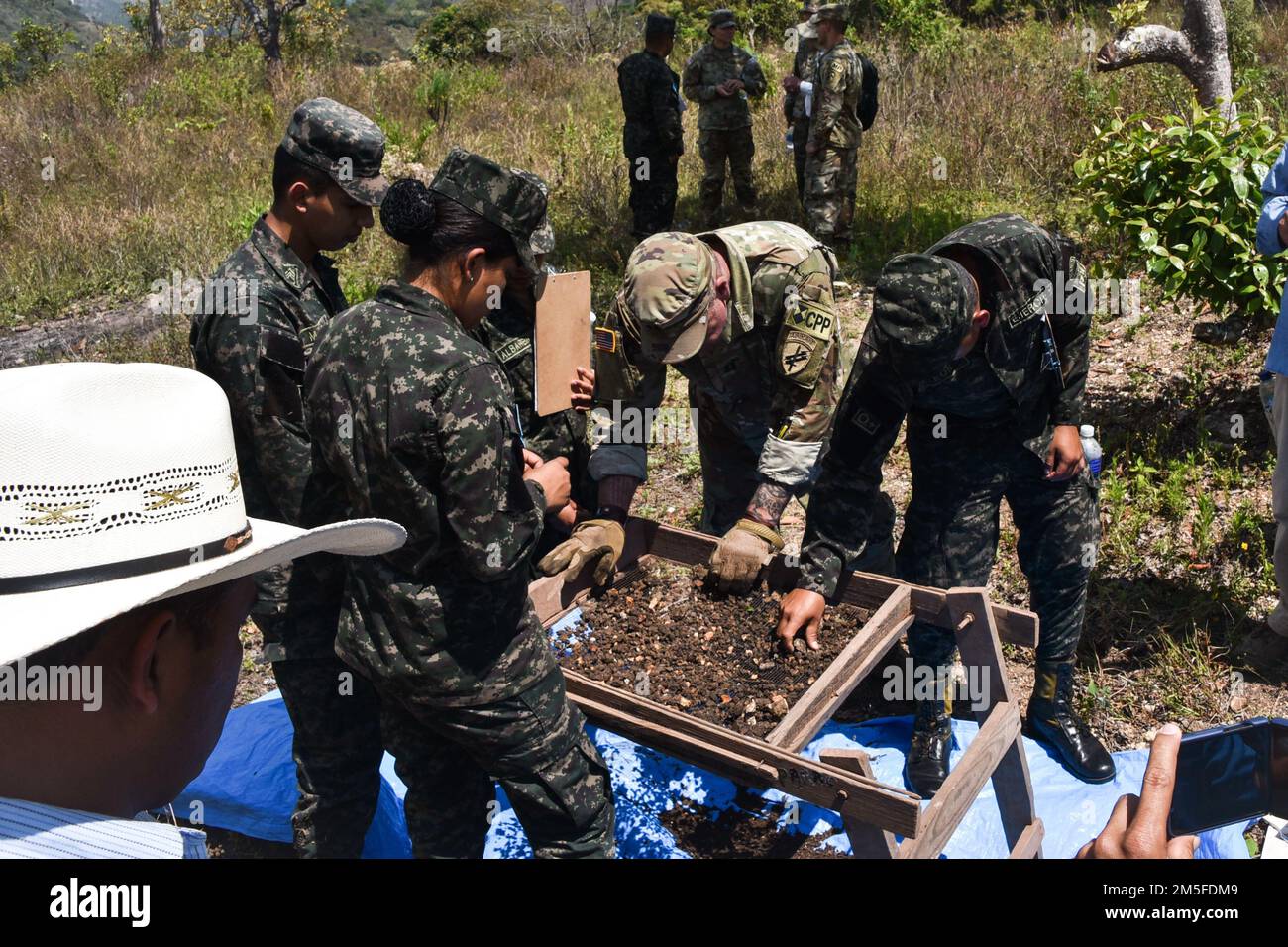 Honduran soldiers with the 120th Infantry Brigade separate soil while ...