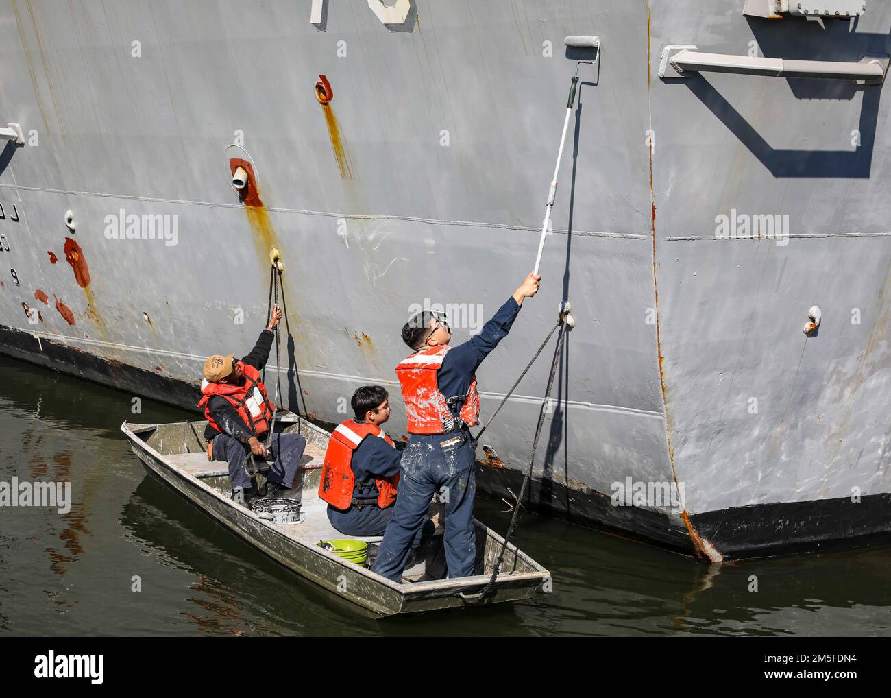 NORFOLK, Va. (March 11, 2022) – Seaman Julian Lopez, right, paints the ...