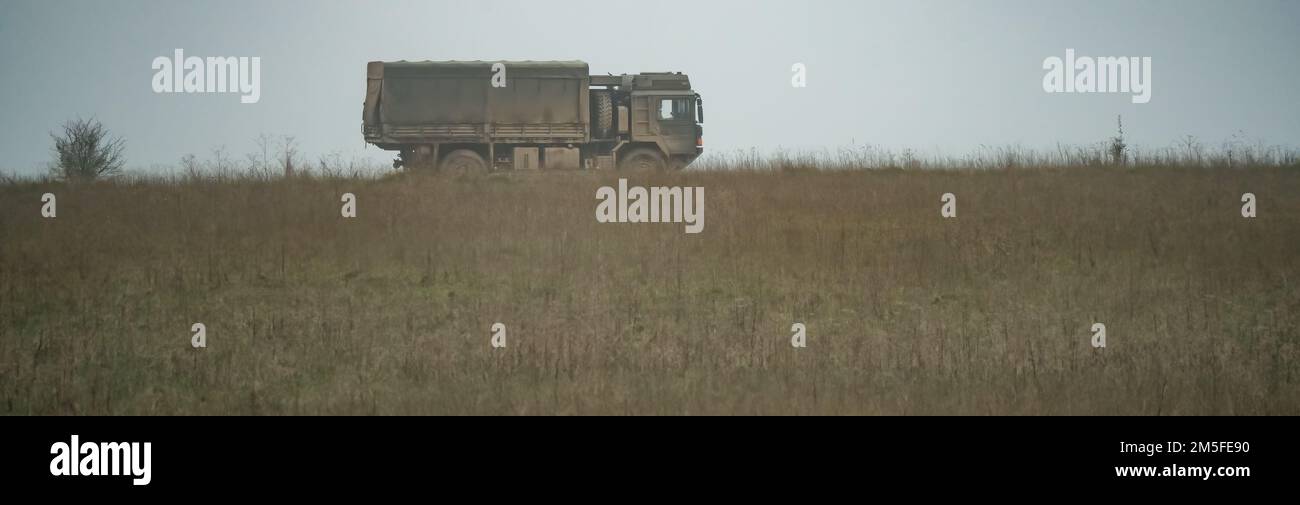 The military truck moving in a field Stock Photo - Alamy