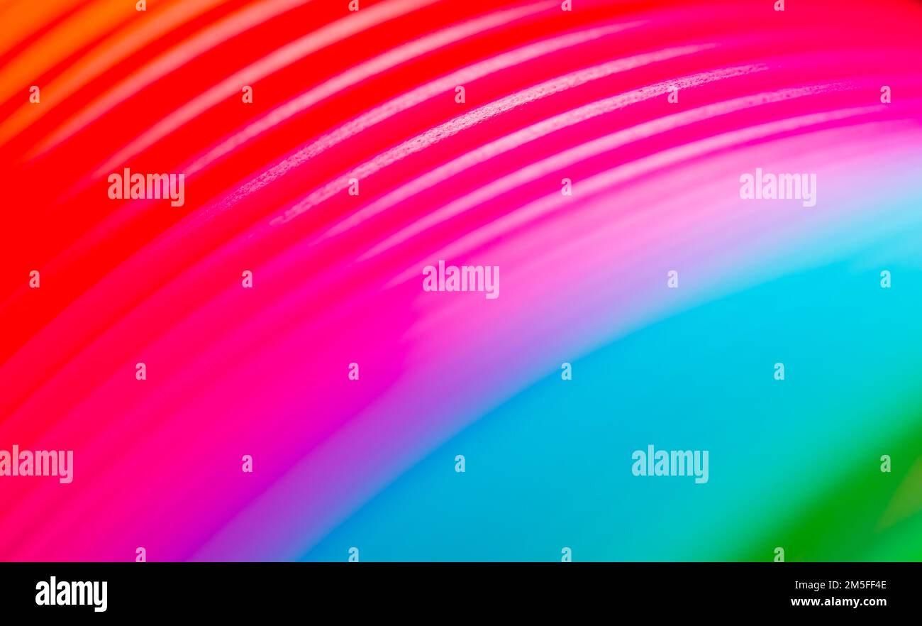 A closeup of a plastic spring rainbow spiral toy - for backgrounds ...