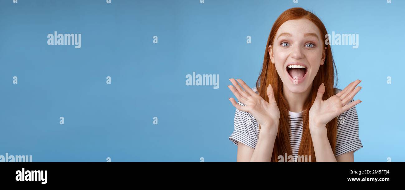 Happy cheerful rejoicing young pretty redhead supportive girlfriend ...