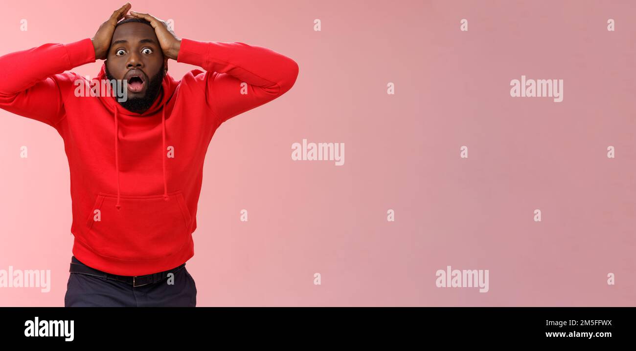 Impressed concerned black guy standing stupor worried grab head shocked ...