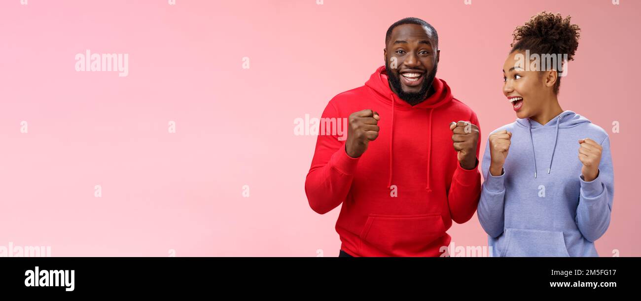 Joyful delighted celebrating african-american woman man standing ...