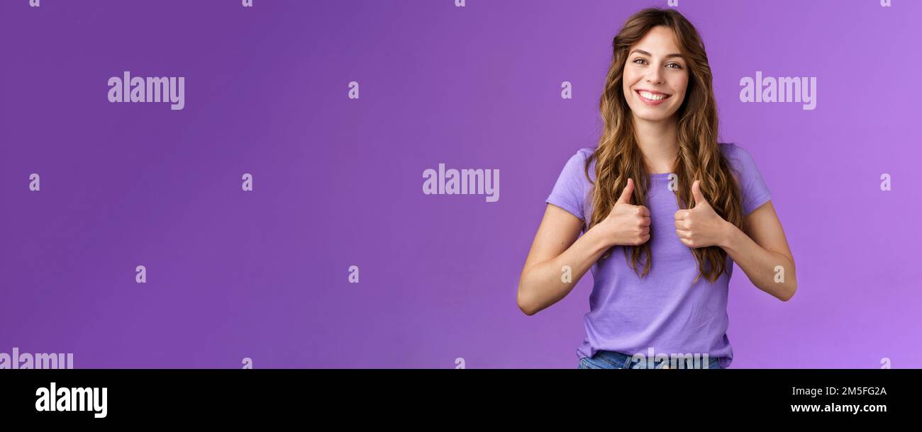 Upbeat positive attractive cheerful curly girl show thumbs up approval ...