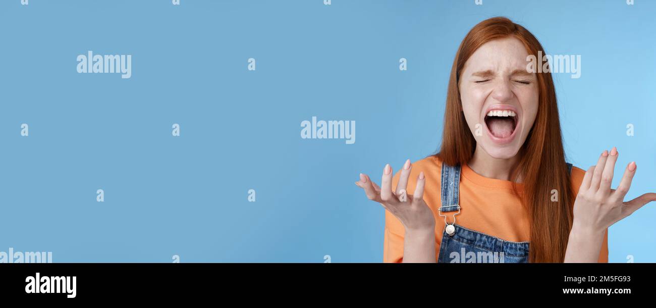 Pissed outraged moody redhead girl shouting complaining angry standing ...