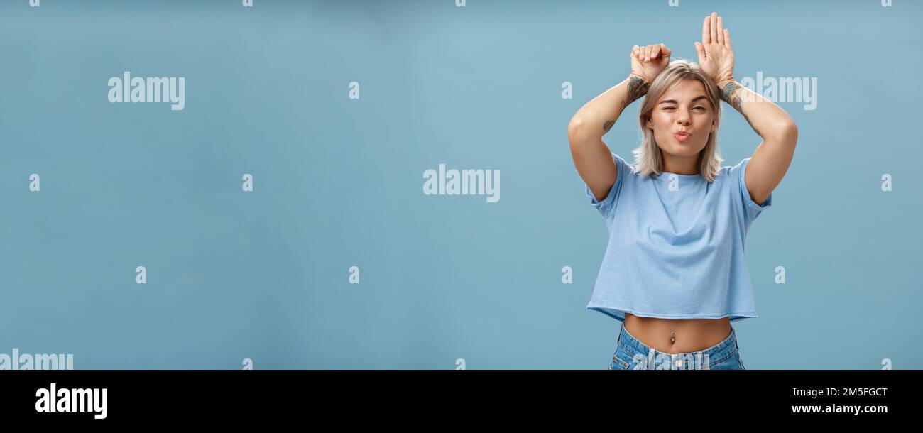 Flirty attractive and stylish cool girlfriend with tattooed arms and ...