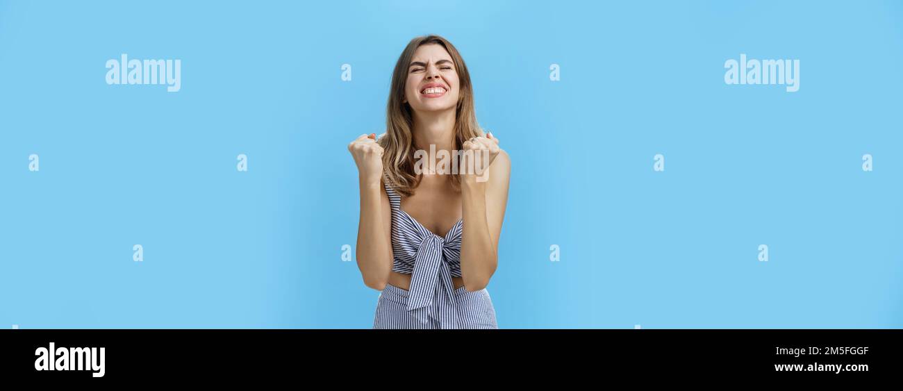 Girl triumphing raising hands in cheer from happiness and victory ...