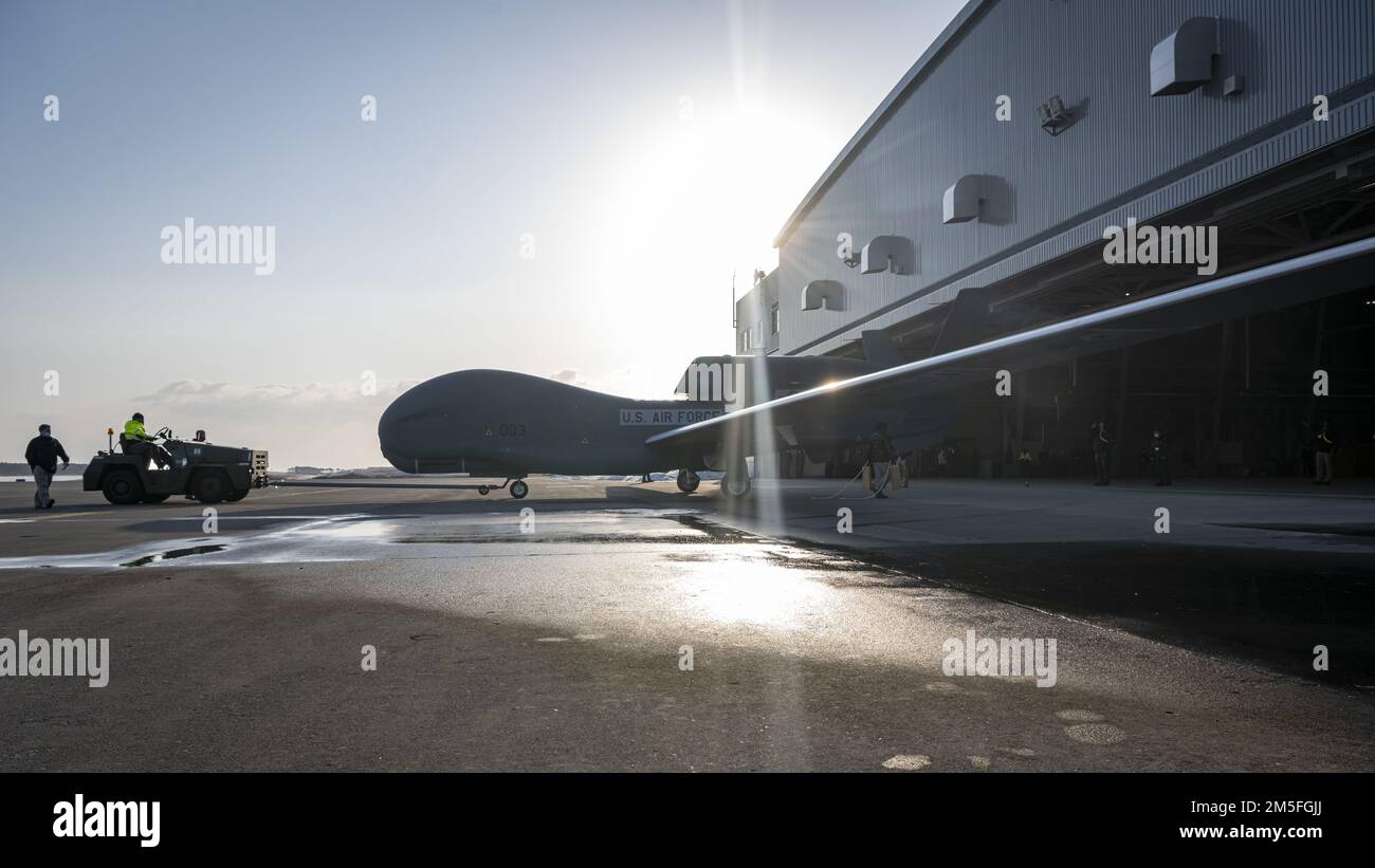An RQ-4B Global Hawk is moved into a hangar on the flight line at ...