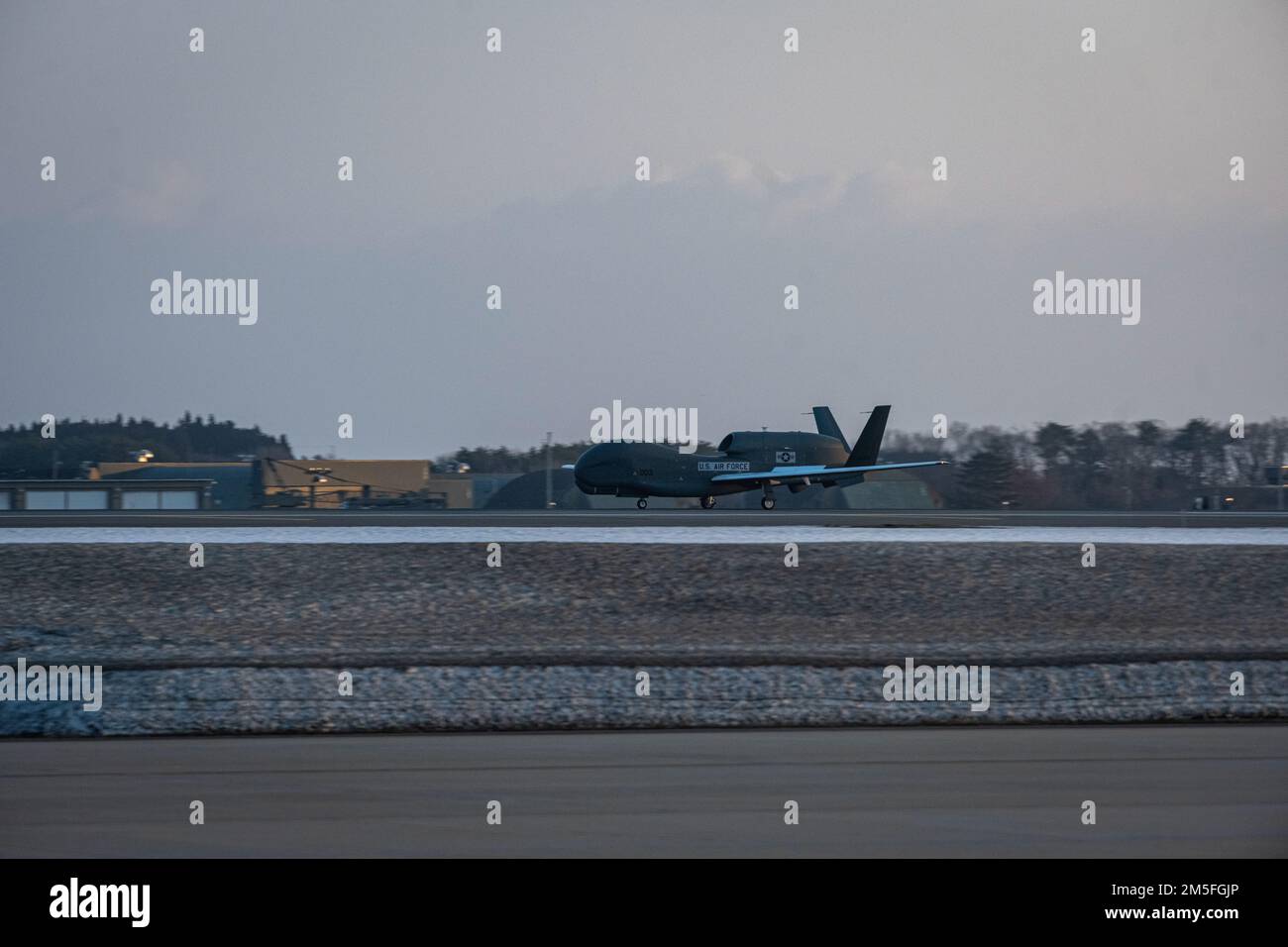 An RQ-4B Global Hawk lands on the runway at Misawa Air Base, Japan ...