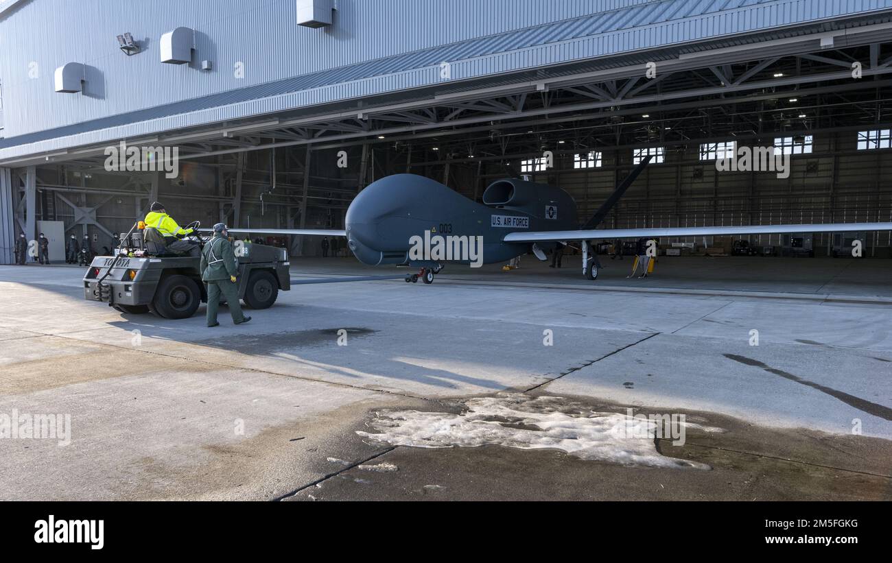An RQ-4B Global Hawk is moved into a hangar on the flight line at ...