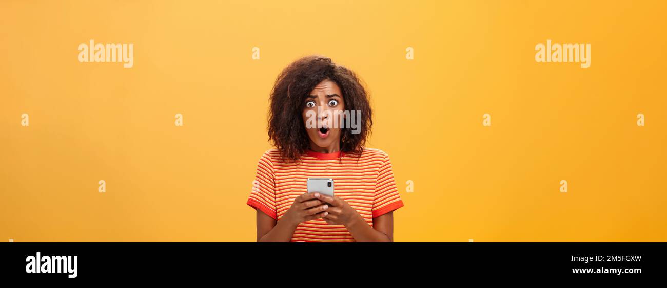 Portrait Of Shocked And Concerned Stunned Dark Skinned Woman With Afro