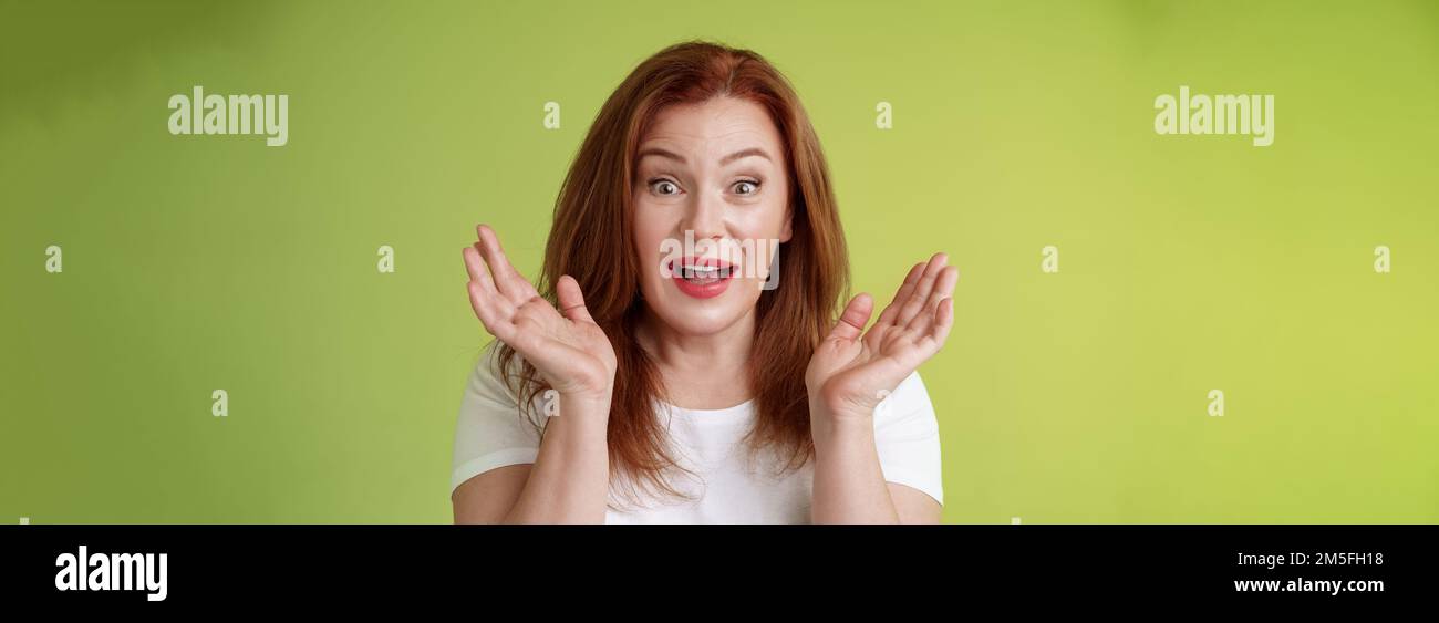 Glad surprised happy redhead middle-aged mother surprised gasping clap ...