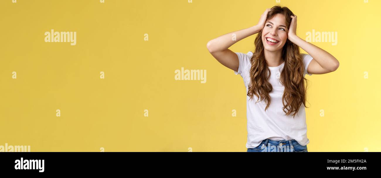 Carefree happy attractive smiling girl hold head curly hairstyle turn ...