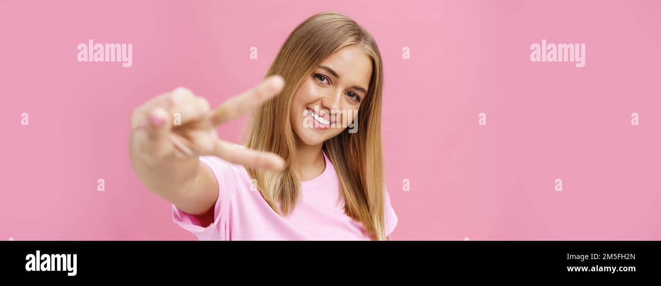 Peaceful and joyful good-looking young girl with straight blond hair in ...