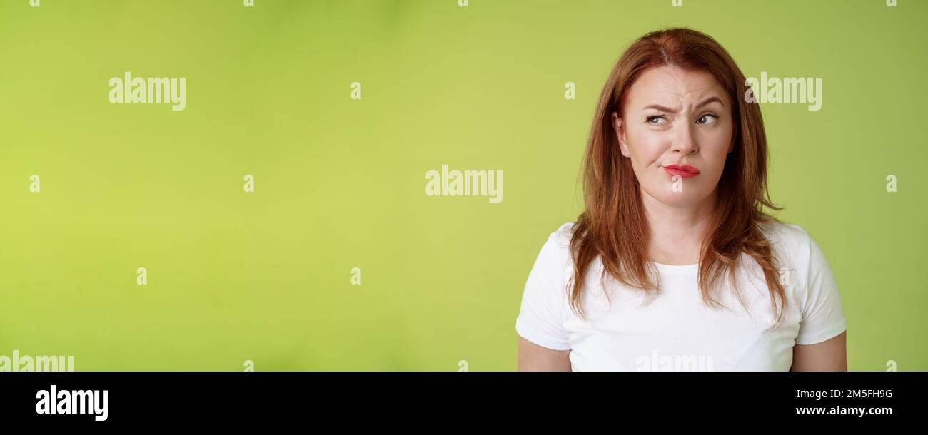 Perplexed doubtful unsure redhead wife smirking unsatisfied frowning ...