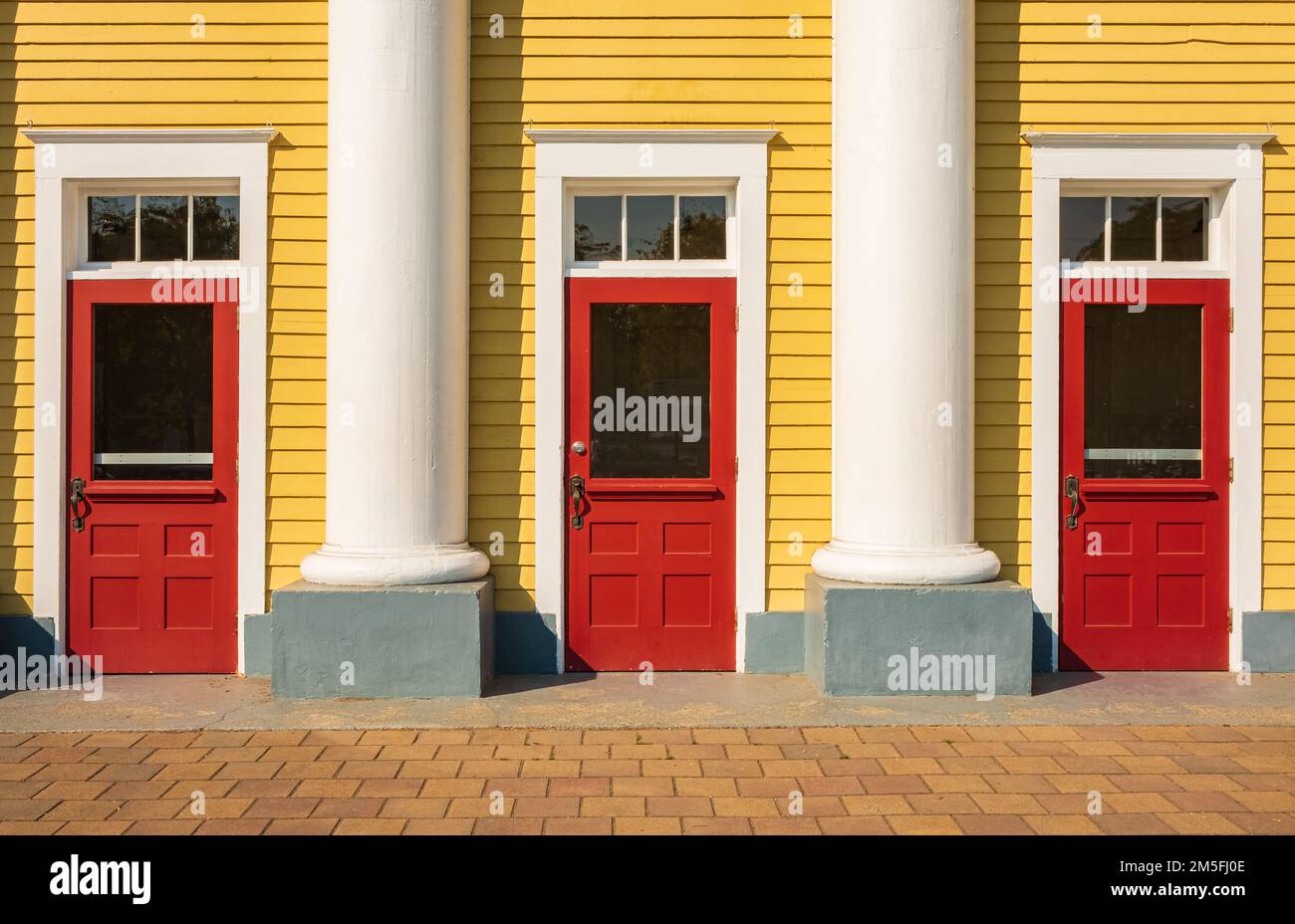 Red doors. Three coloured front doors at the entrance of an old ...