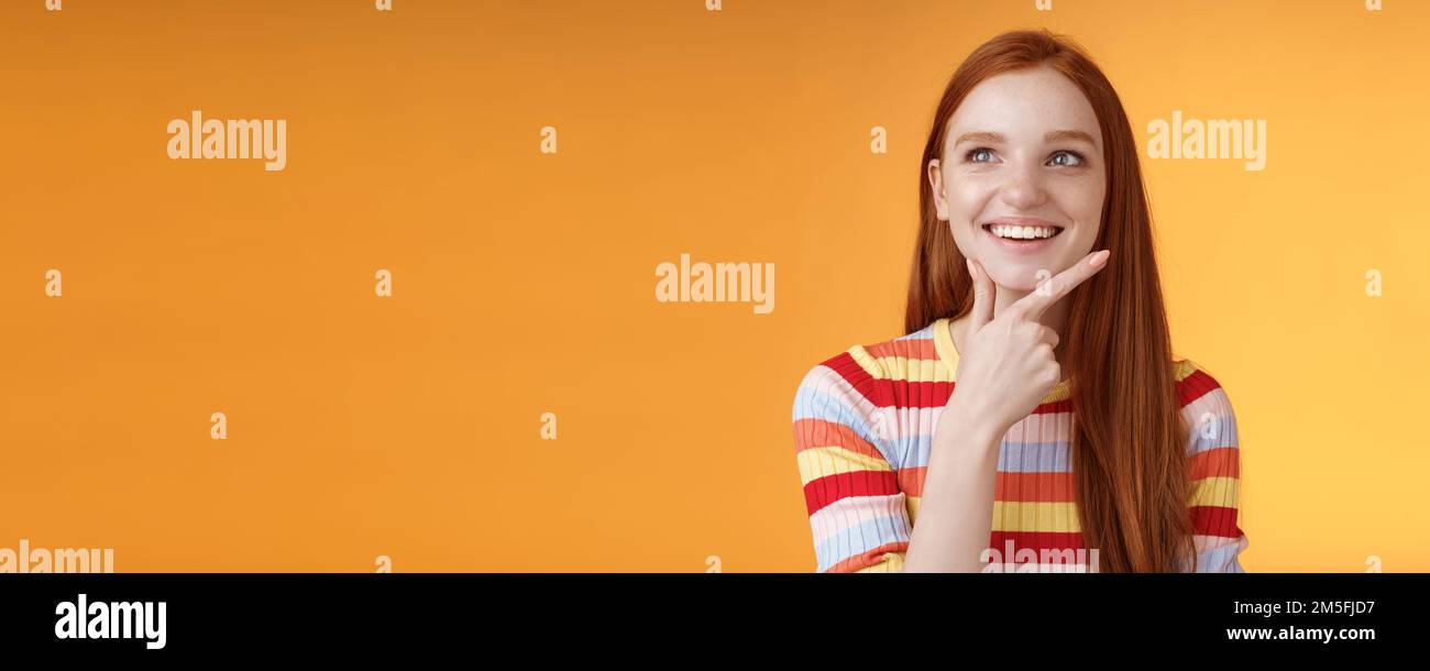 Creative satisfied smart redhead girl got excellent idea touching chin ...