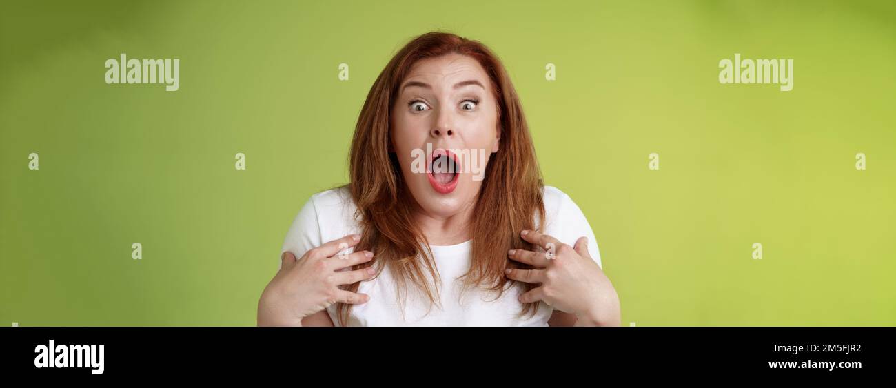 Shocked panicking redhead middle-aged woman gasping drop jaw open mouth ...