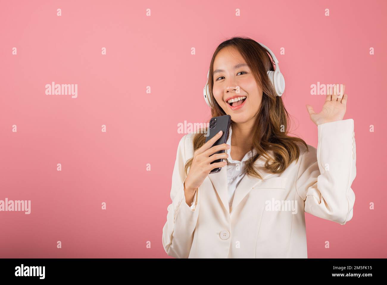 Woman excited smiling listening to music radio in bluetooth headphones ...
