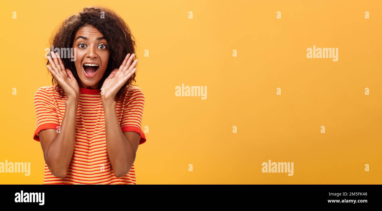 Waist-up shot of impressed excited talkative dark-skinned woman with ...