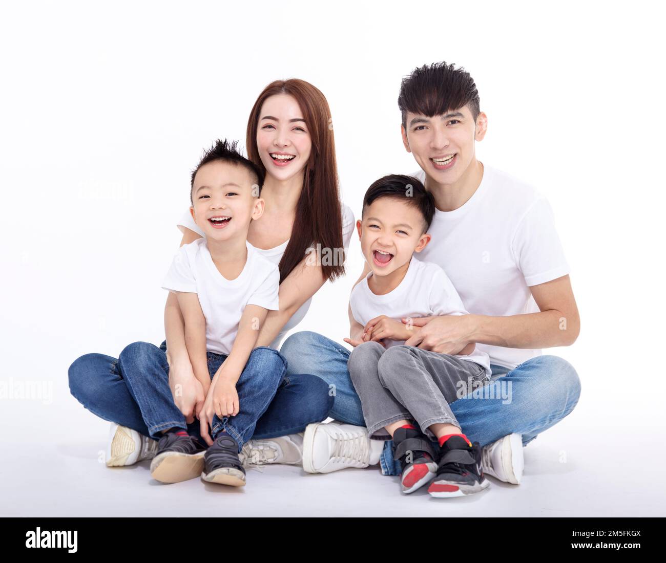 Happy Asian family and kids sitting on white floor Stock Photo - Alamy