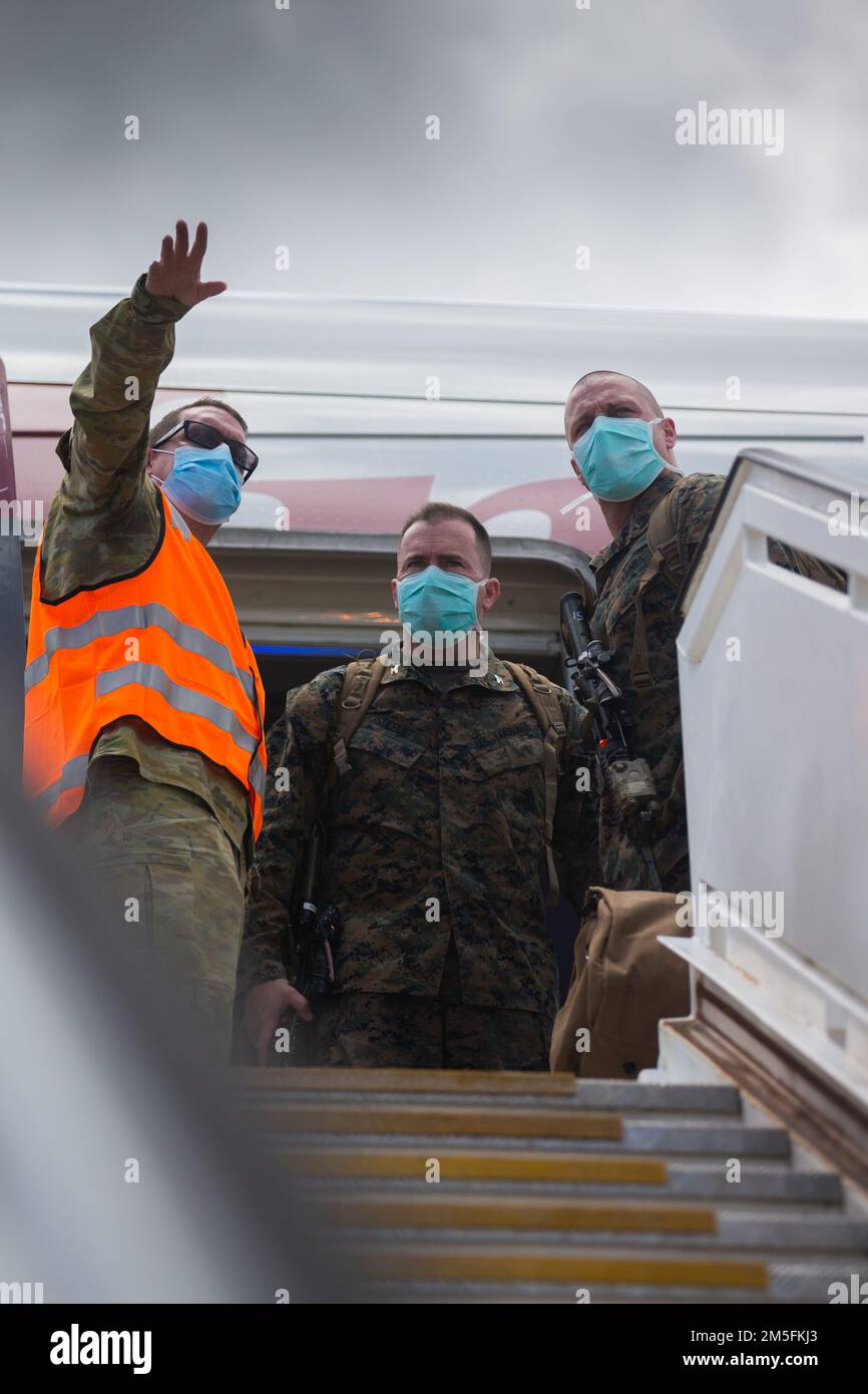 From left, an Australian Soldier directs U.S. Marine Corps Col ...