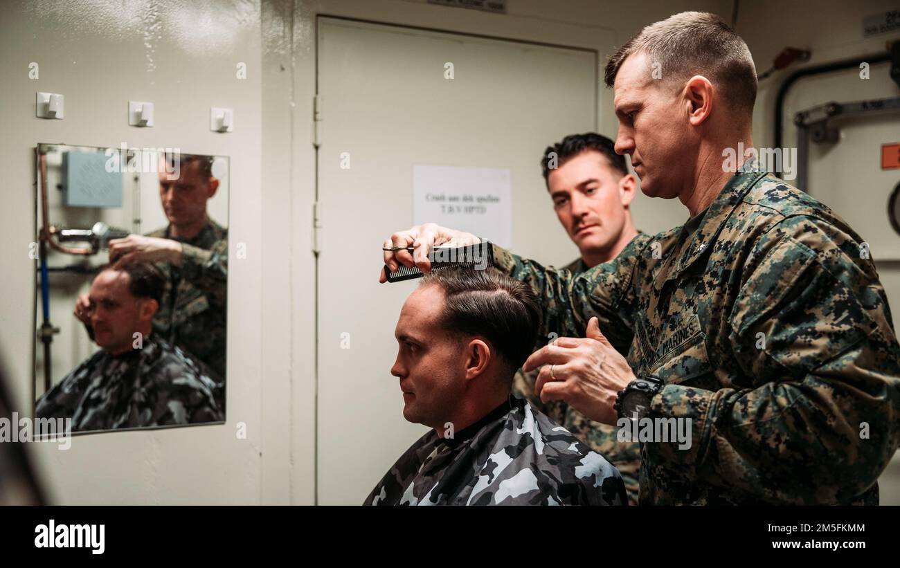 U.S. Marine Corps Lt. Col. Ryan Gordinier demonstrates hair cutting ...