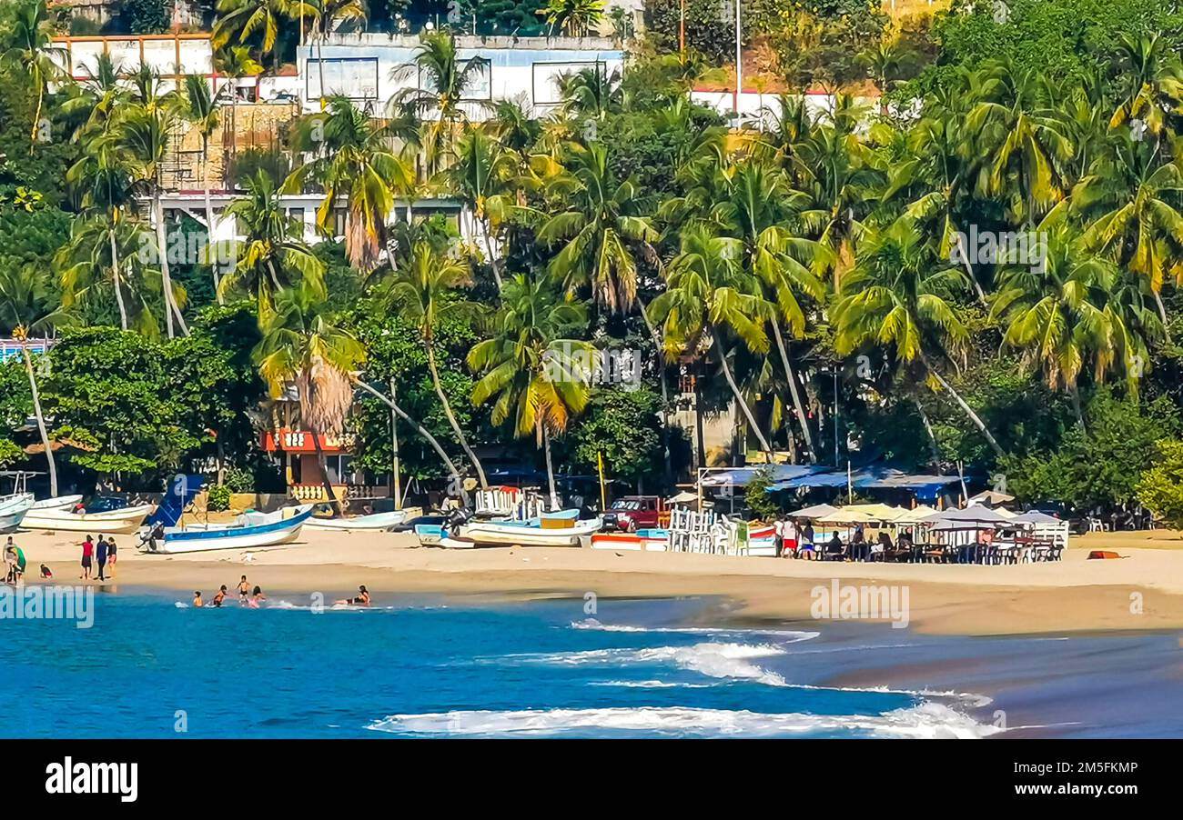 Sun beach people waves and boats in Zicatela Puerto Escondido Oaxaca ...