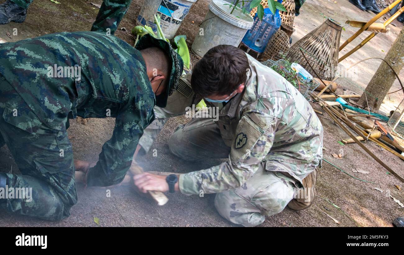 A Royal Thai Army jungle survival instructor helps 1st Lt. Angus ...